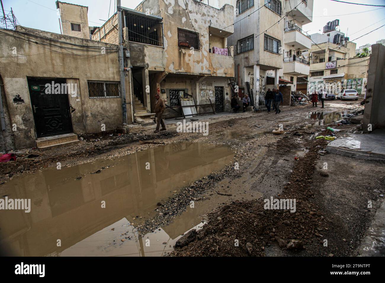Jenin, Palestine. 26th Nov, 2023. People inspect damaged buildings ...