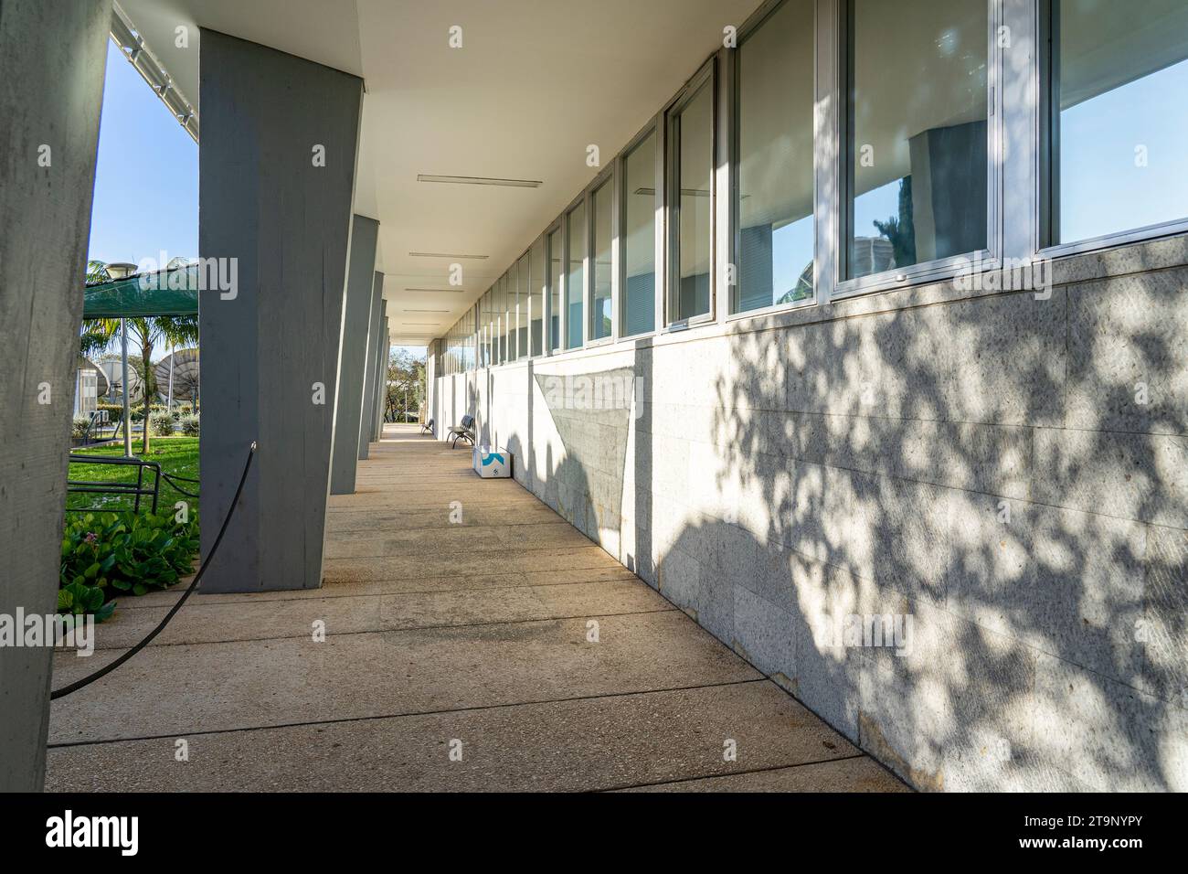 exterior corridor with plastic benches in the headquarters building of ...