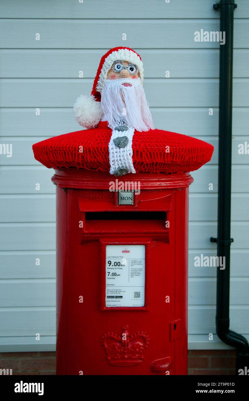 Father Christmas on top of the red post box Stock Photo - Alamy