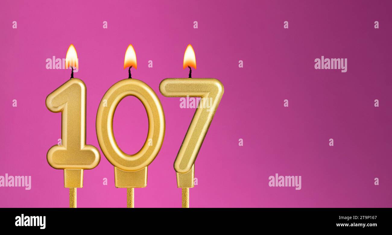 Candle number 107 in purple background - birthday card Stock Photo - Alamy