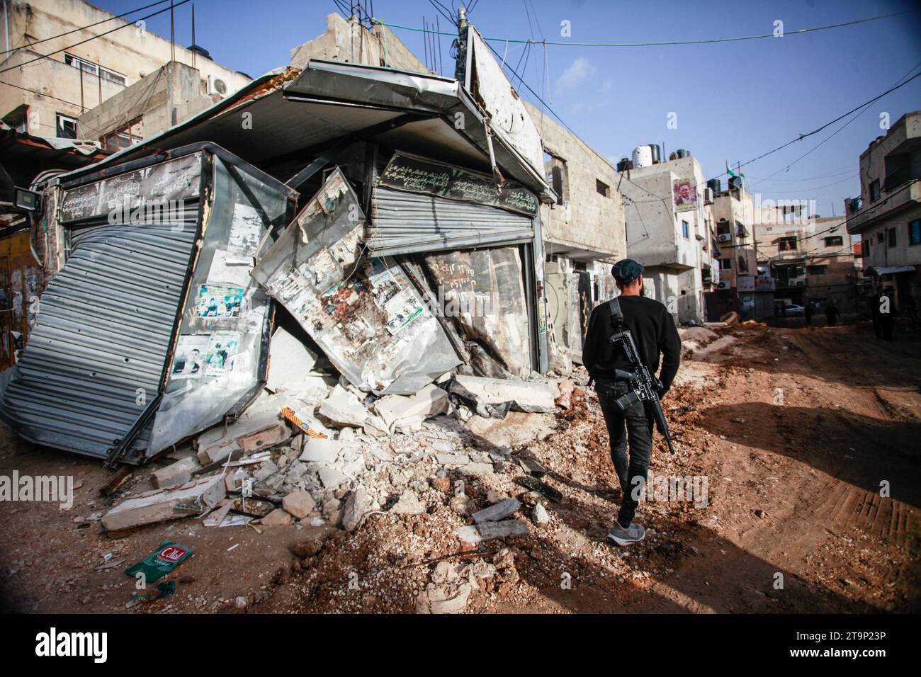 Jenin, Palestine. 26th Nov, 2023. A Palestinian gunman inspect a ...