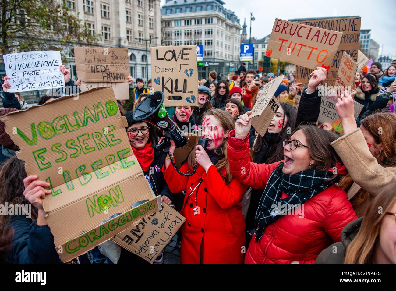 Women wearing red clothes are surrounded by other women shouting ...