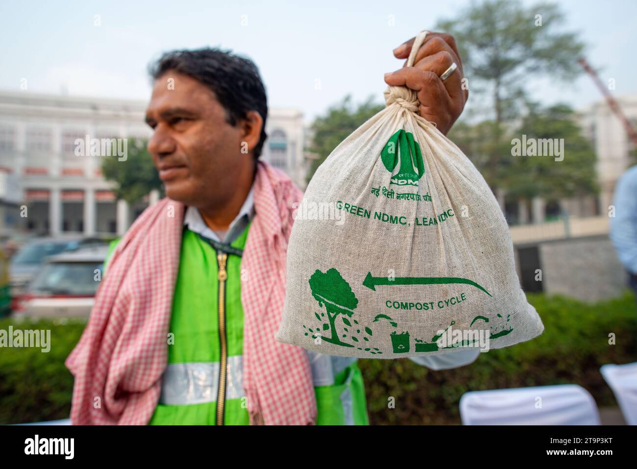 An NDMC worker is distributing free compost fertilizer packets made ...