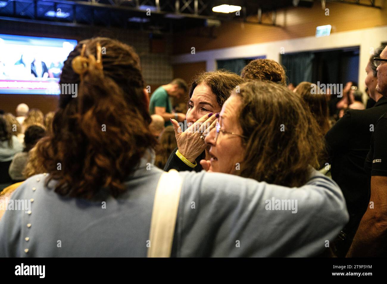 Israel. 26th Nov, 2023. Women cry and hug as members of Kibbutz Kfar ...