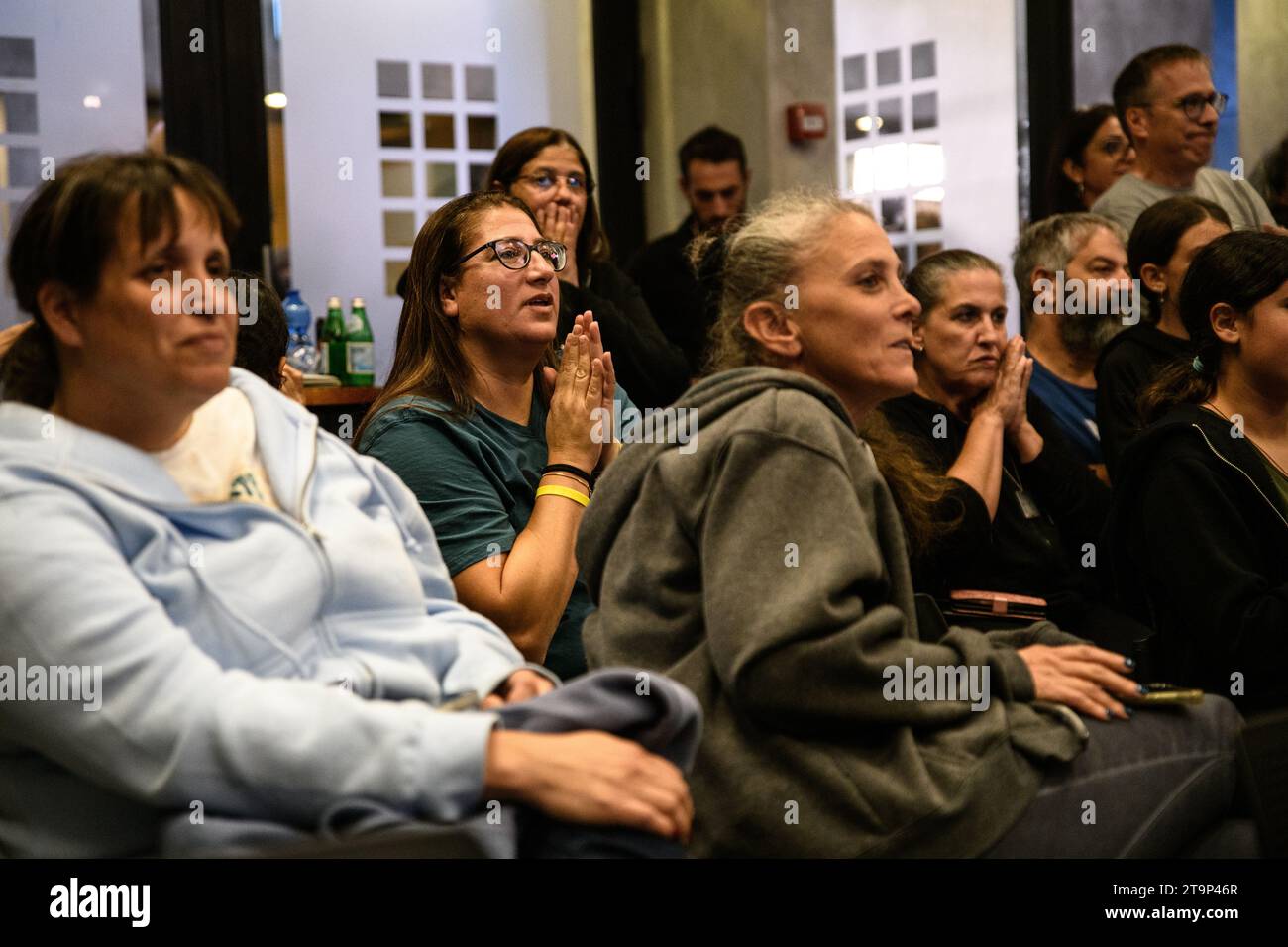 Israel. 26th Nov, 2023. Members of Kibbutz Kfar Azza gather to watch ...