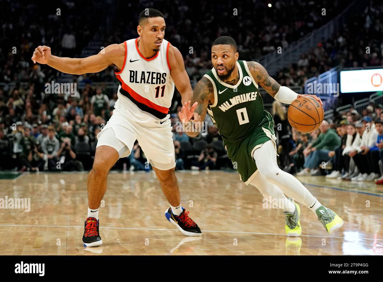 Milwaukee Bucks' Damian Lillard (0) drives to the basket against ...