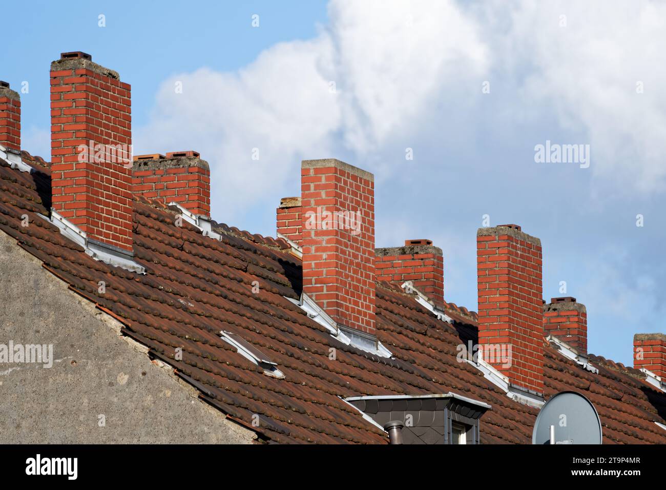 many brick chimneys on the roof of an old apartment building Stock ...