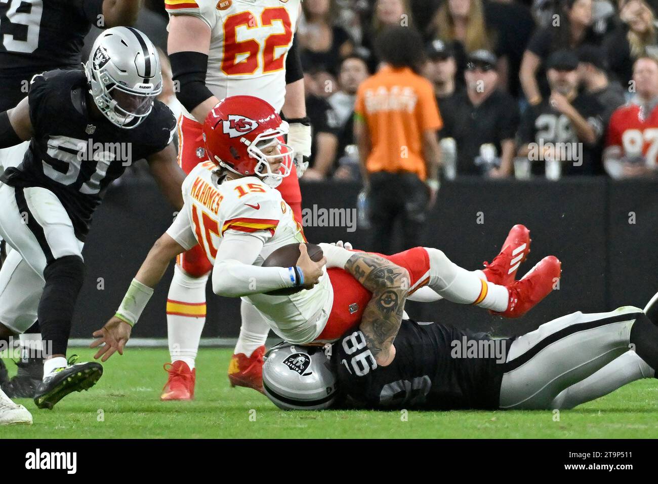Kansas City Chiefs quarterback Patrick Mahomes (15) is sacked by Las Vegas Raiders defensive end ...