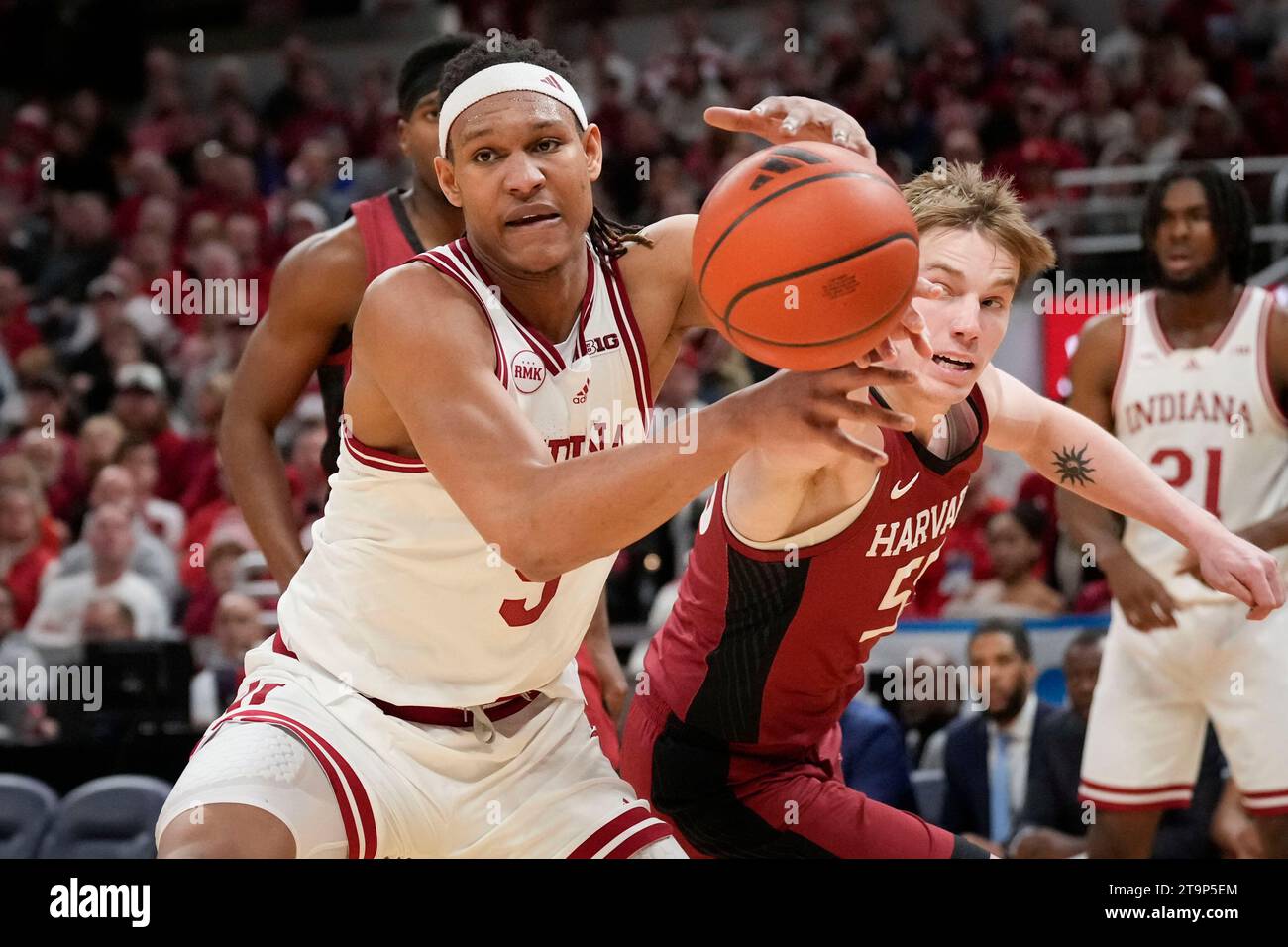 Indiana forward Malik Reneau, left, chases the ball with Harvard center ...