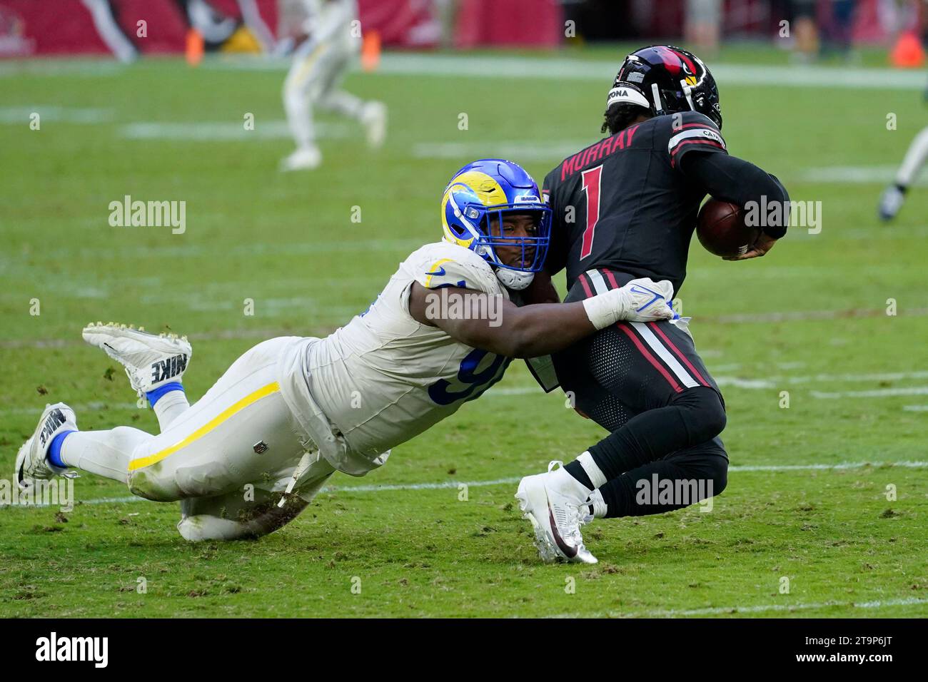 Los Angeles Rams defensive tackle Kobie Turner, left, sacks Arizona ...