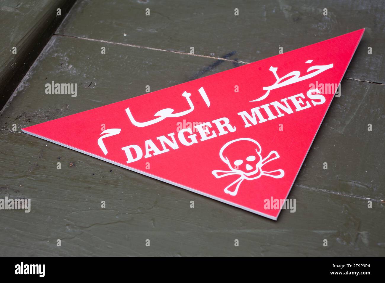 Arabic and English minefield warning red sign. Danger Mines. White ...