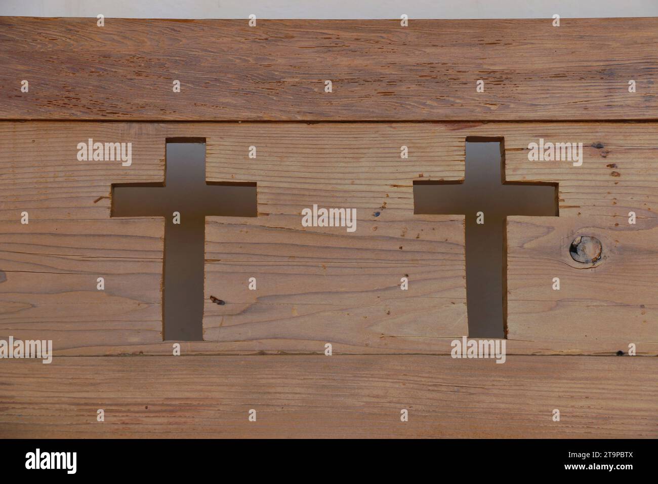 Silhouettes of two crosses carved into a wooden bench at the Mission ...