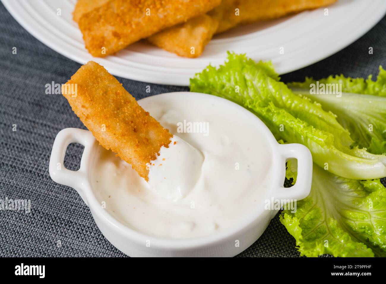 Fish sticks in a crunchy golden breading and bowl of greek yogurt ...