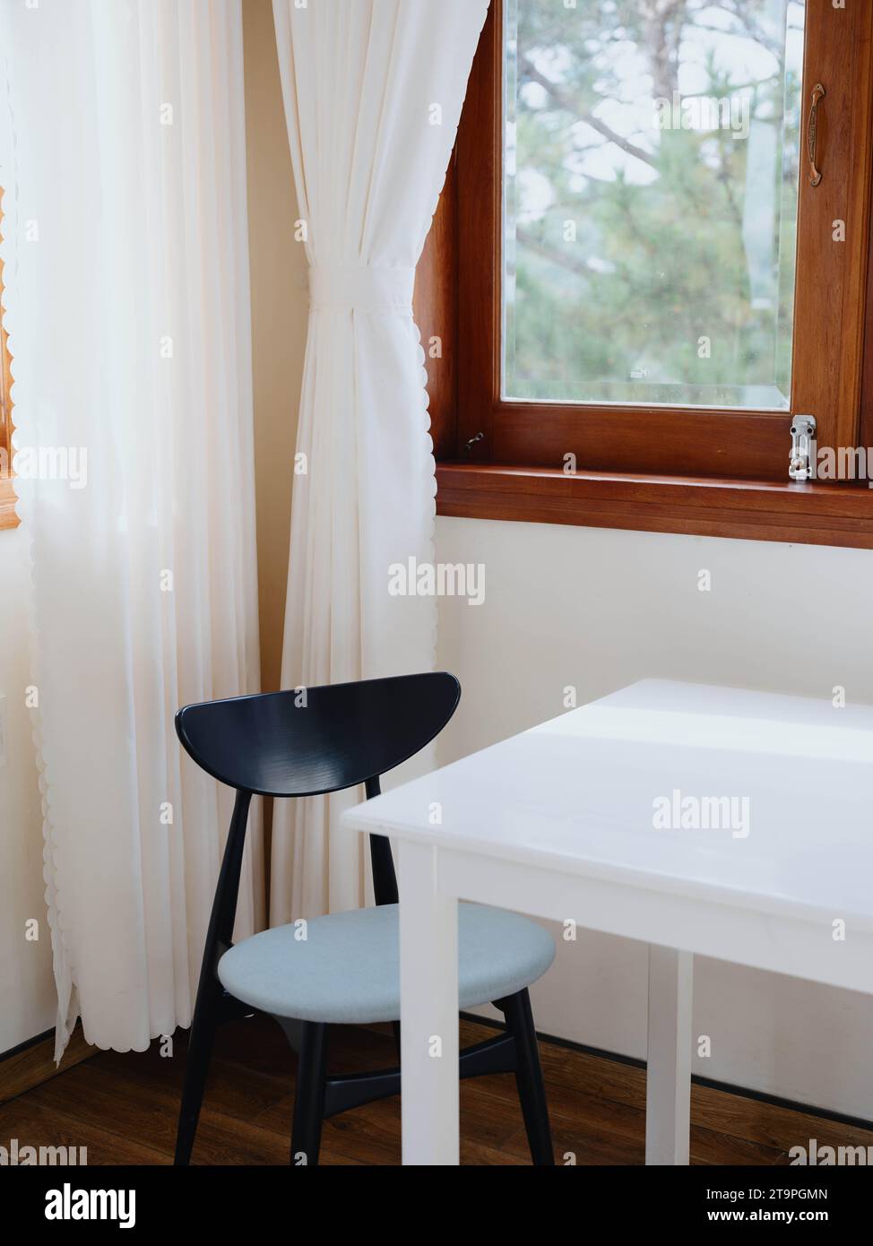 Empty dining table with chairs in light interior by window, cozy design ...