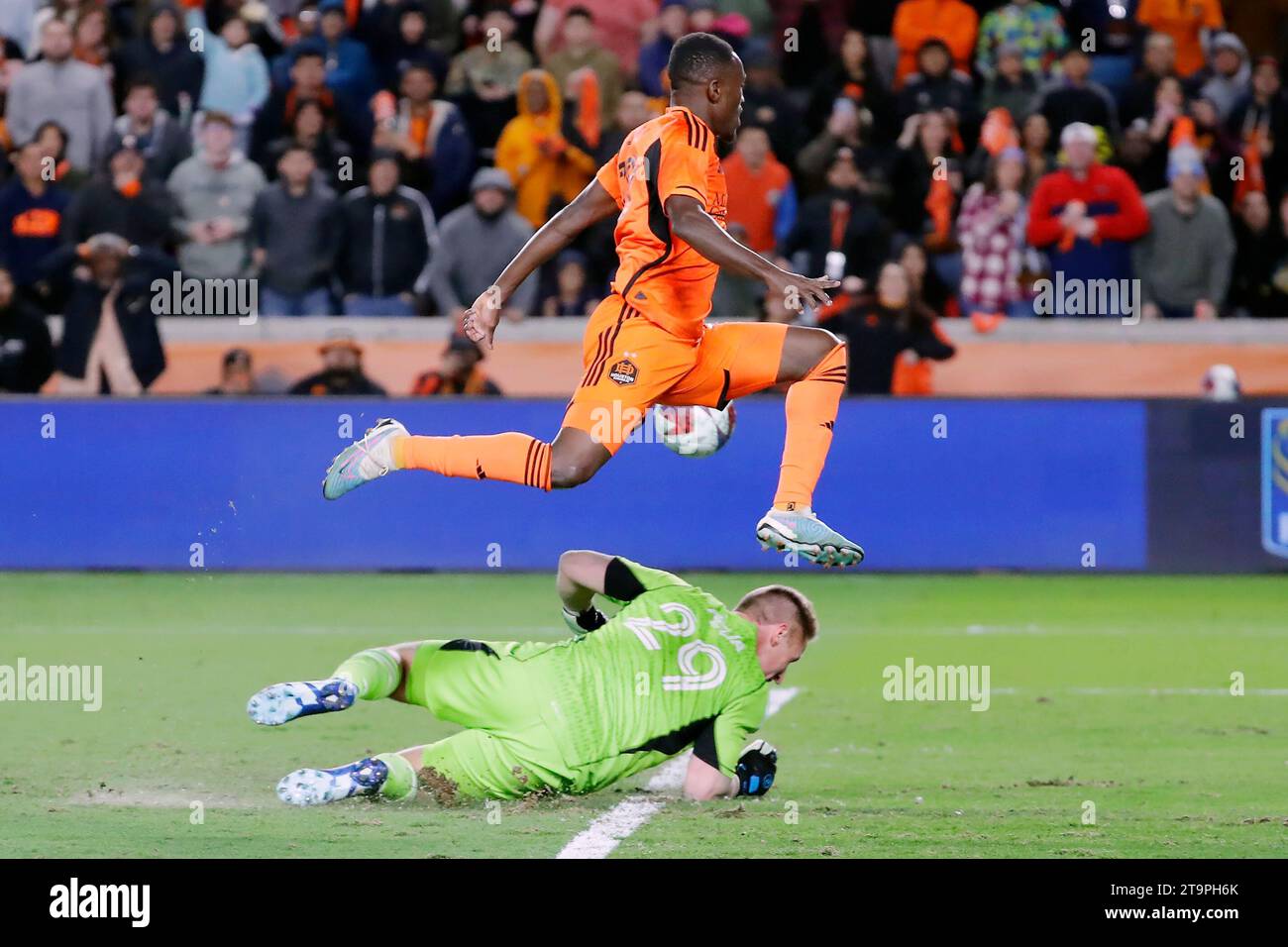 Houston Dynamo forward Ibrahim Aliyu, top, jumps over Sporting Kansas ...