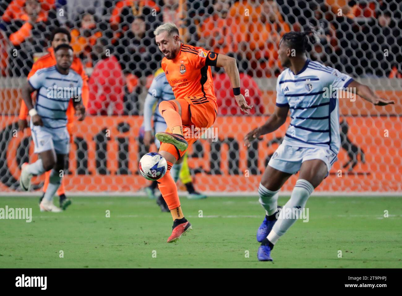 Houston Dynamo midfielder Hector Herrera, center, brings the ball down ...