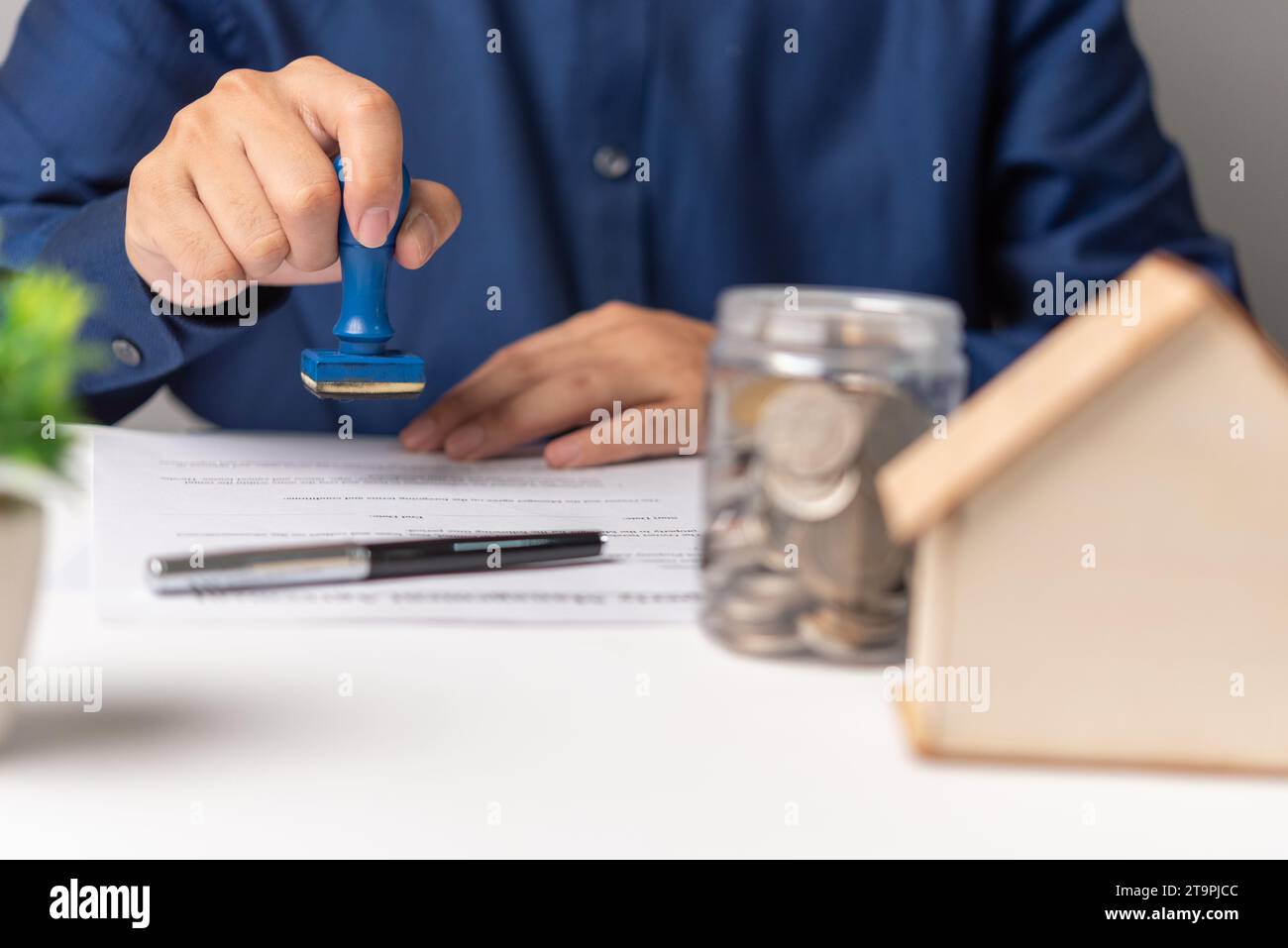 real estate agent with house. Business person holding a rubber stamping ...