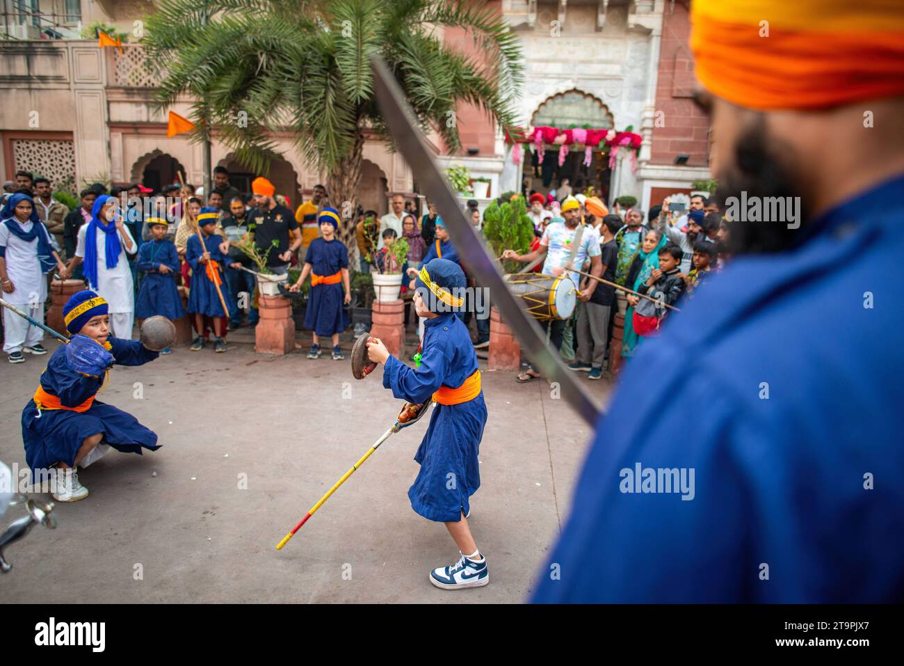 Sikh boys enthusiastically demonstrate their martial arts skills during ...