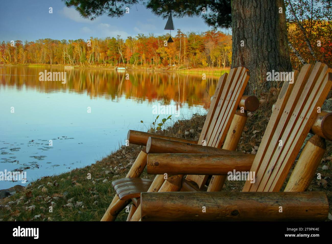 Cabin view of calm lake reflection with brightly autumn colored ...