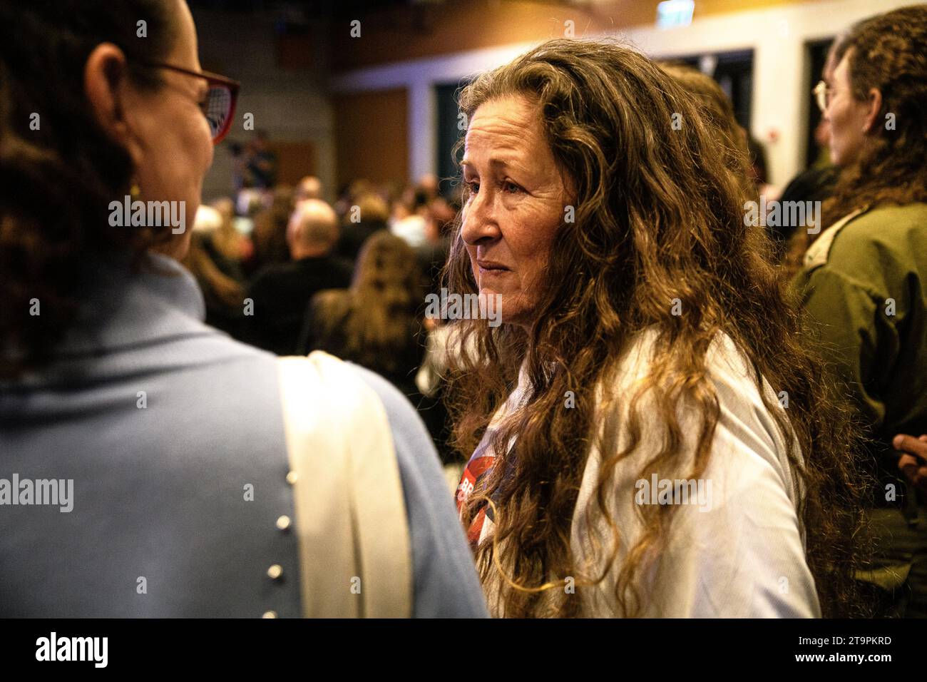 Shfaim, Israel. 26th Nov, 2023. A Kfar Azza member tearsas members of ...