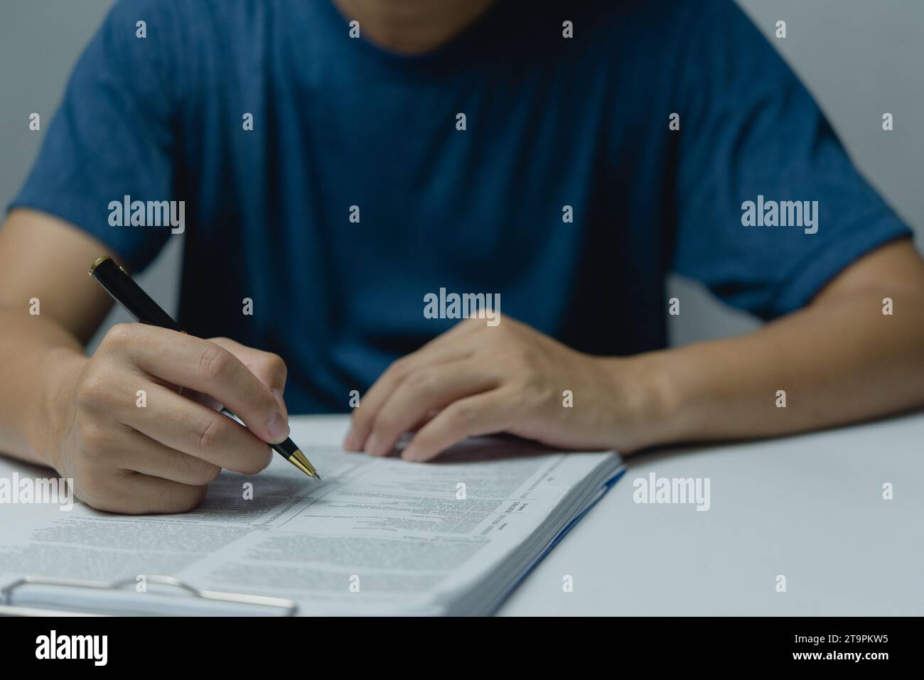 Hand holding pen checklist paper work on desk. Signing information ...