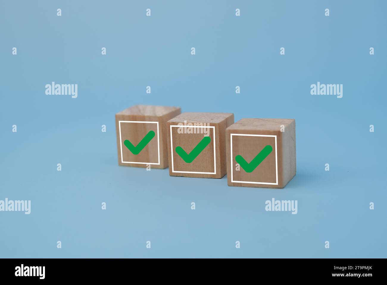 Wood cube with a check mark on background. Checklist concept list, vote ...