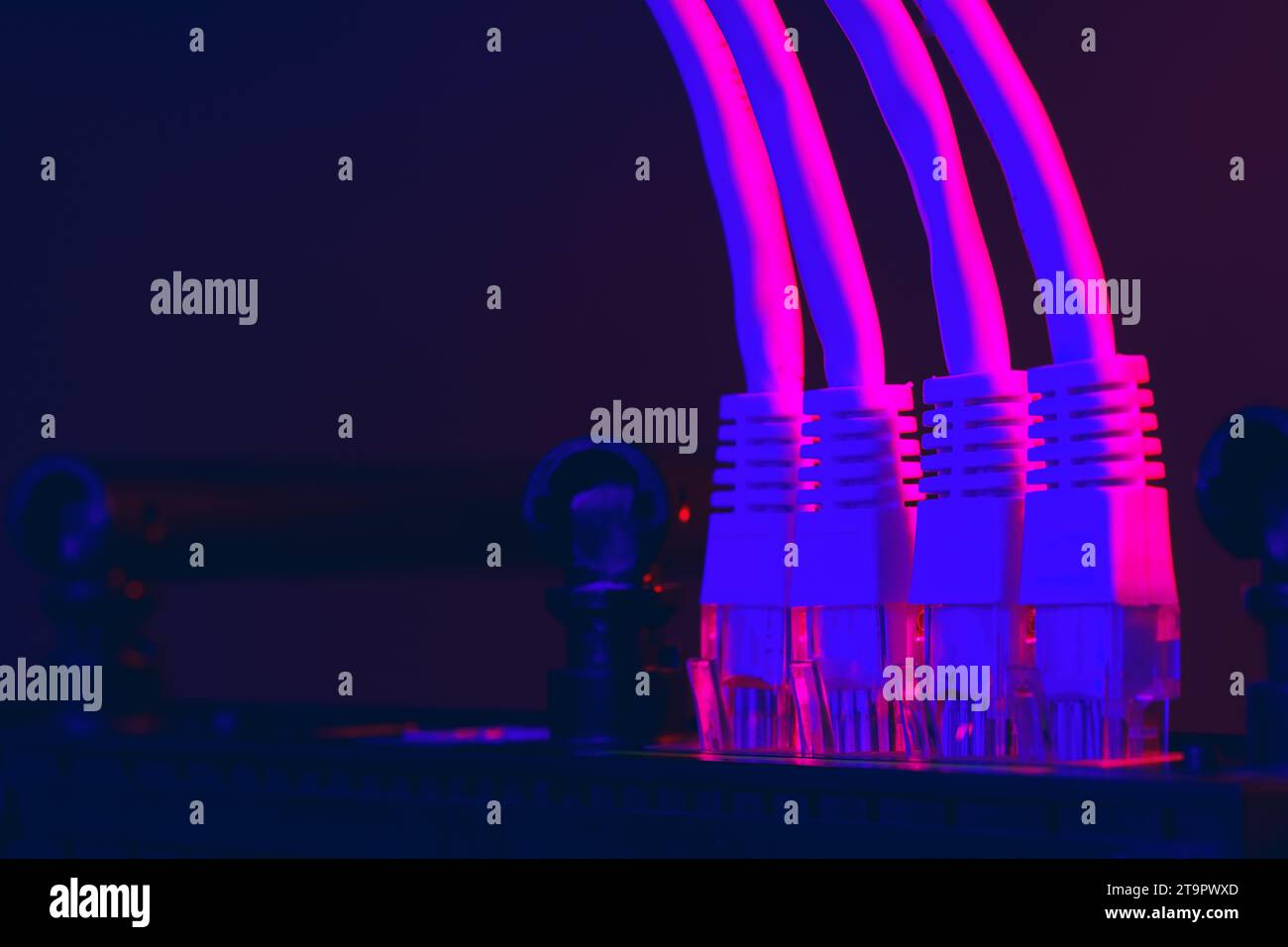 Cables plugged in a Wi-Fi router on dark background Stock Photo - Alamy