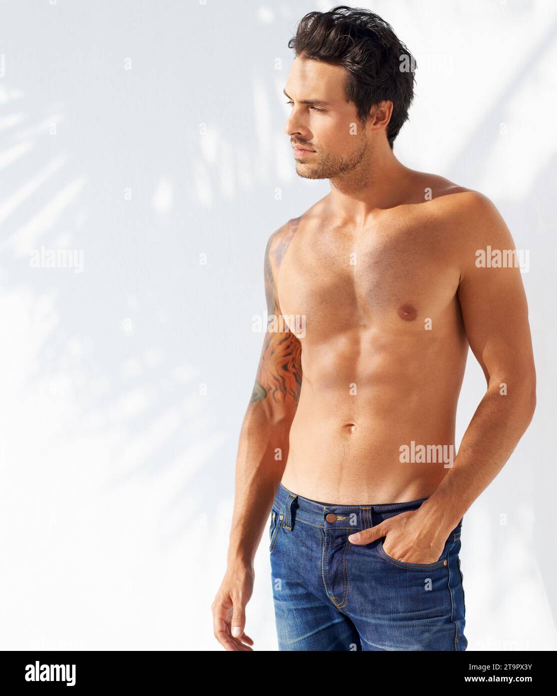 Thinking, body and man profile by a white wall outdoor in the sun with ...