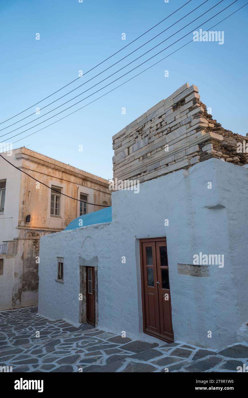 A picturesque landscape with a cluster of traditional white buildings ...