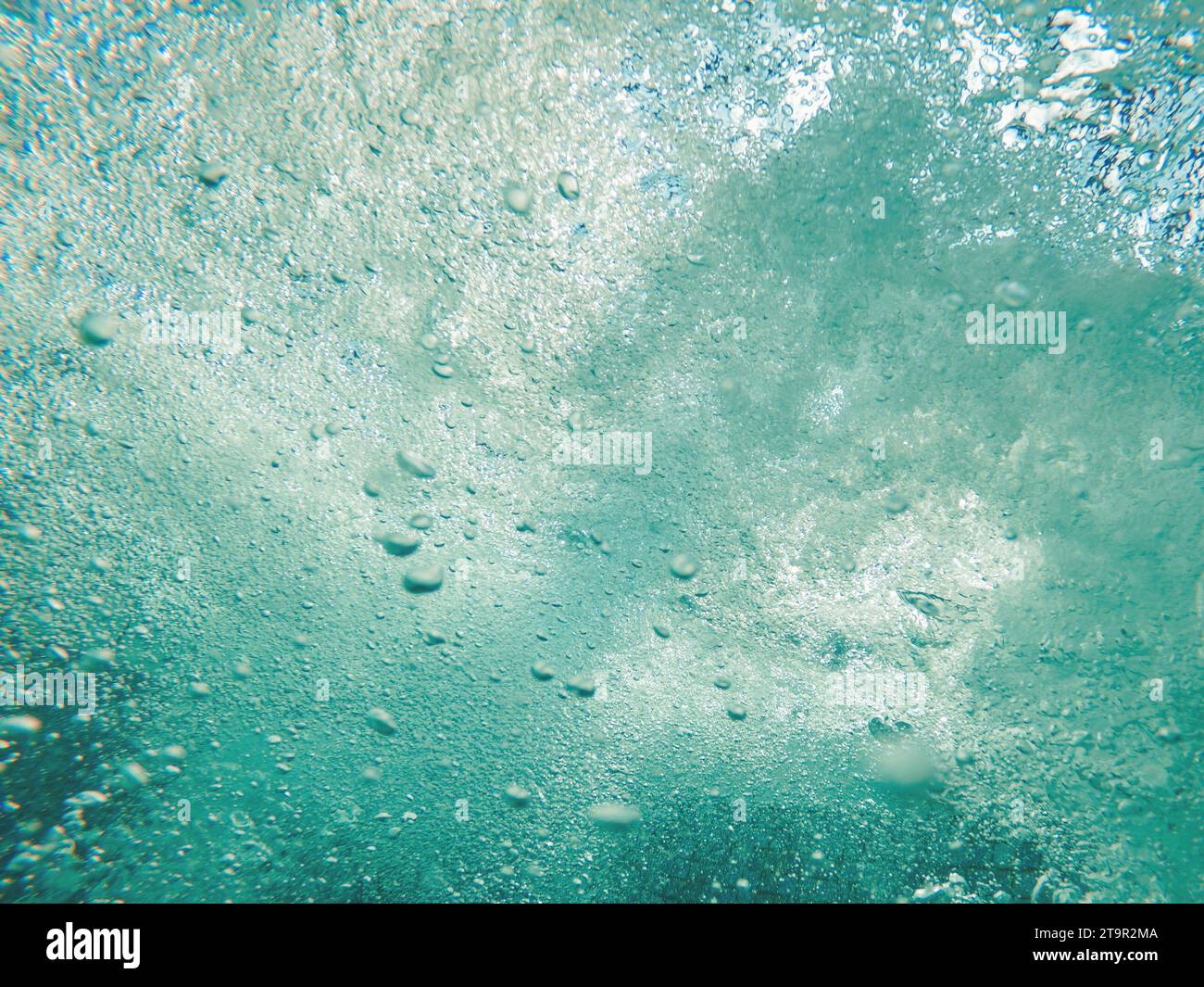 Underwater air bubbles in clean blue ocean water as natural background ...