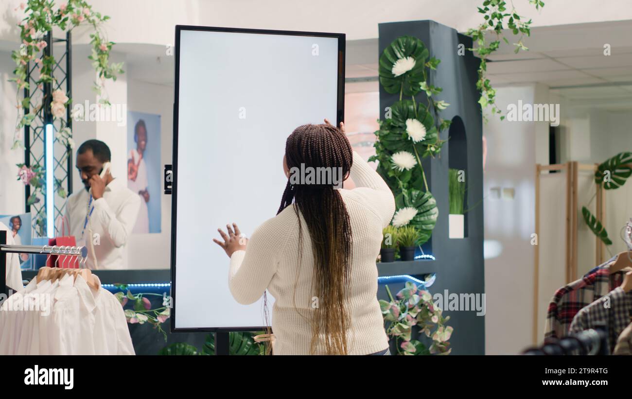 African american woman in fashion boutique using mockup augmented ...