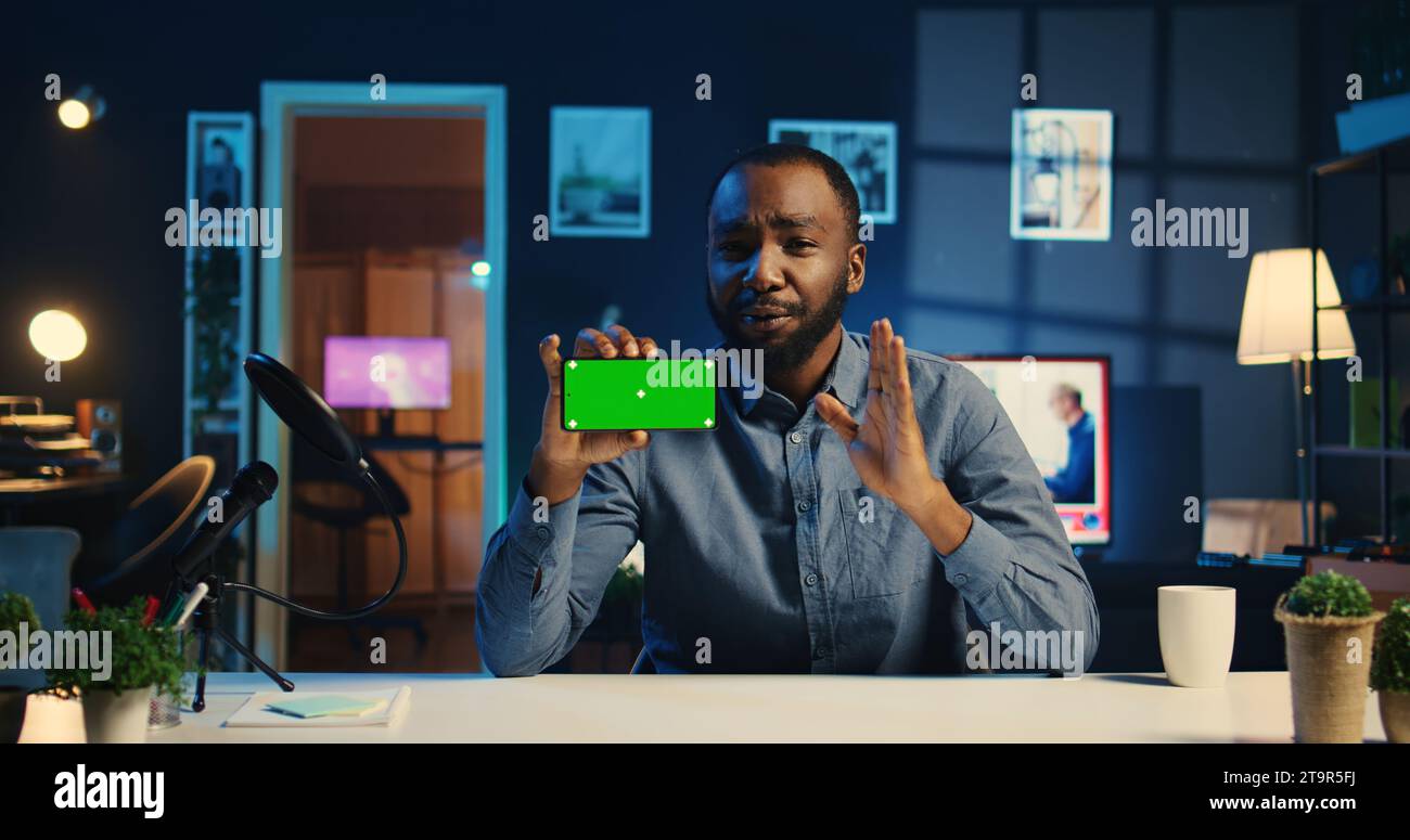 Happy content creator holding chroma key product, being sponsored by ...