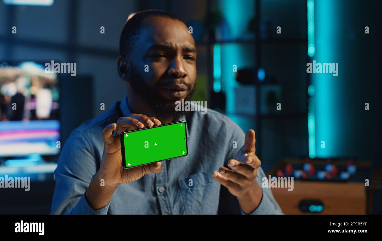 Content creator in studio films newly released chroma key smartphone ...