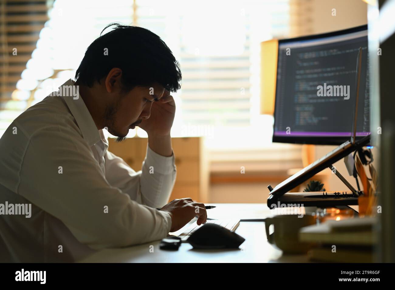 Shot stressed male software developer programming code on computer screen Stock Photo - Alamy