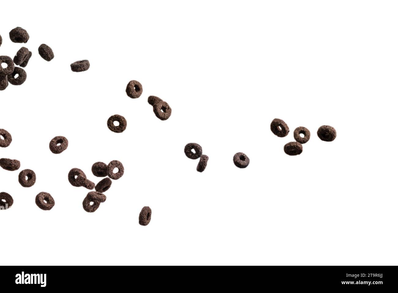 Chocolate rings cereal spill out into a bowl. Breakfast. Isolated on a ...