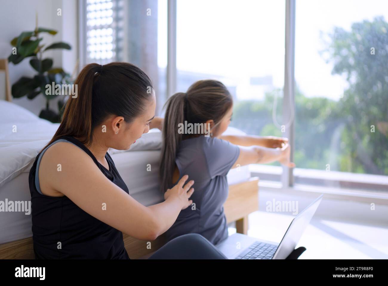 Two women paly yoga at home. Healthy lifestyle and leisure concept ...