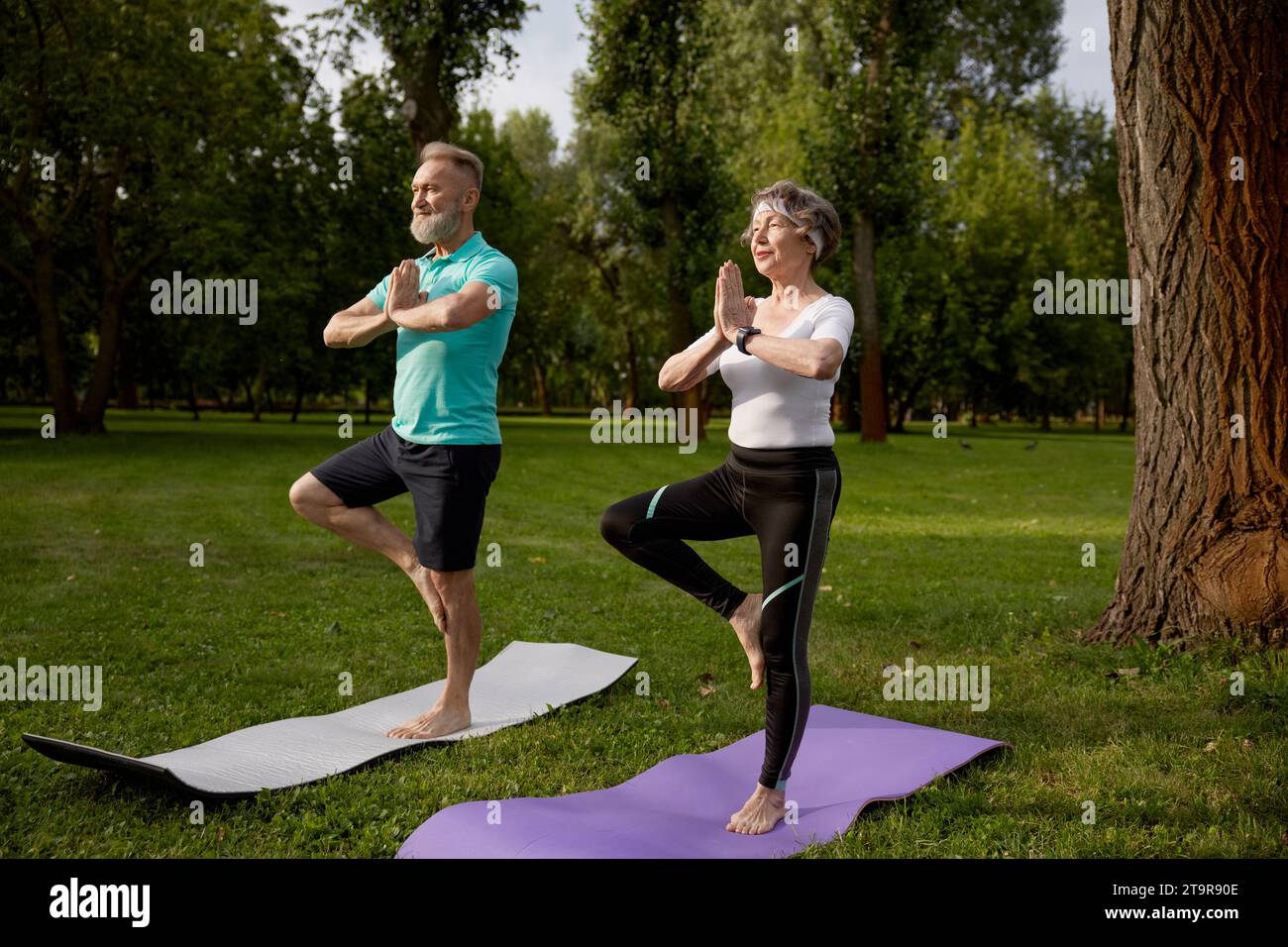 Older active couple doing yoga exercise outdoors at city park Stock ...