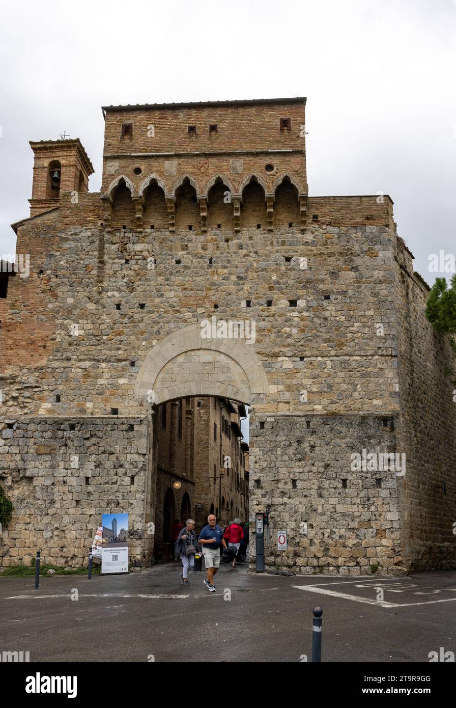 San Gimignano, Italy - Sept 17, 2022: Tourists entering the historic ...