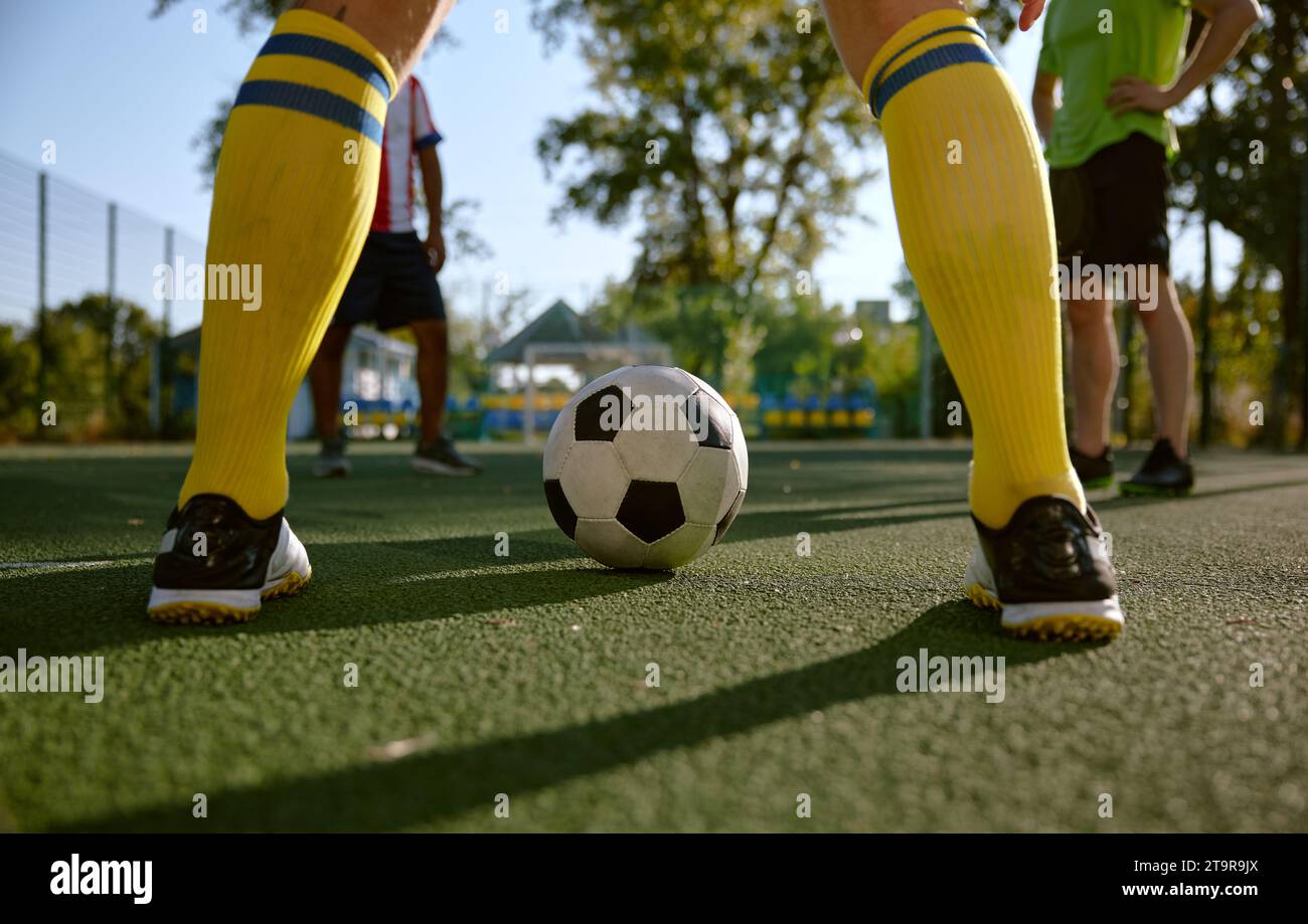 Closeup soccer ball and sportsman legs over grass football field Stock ...