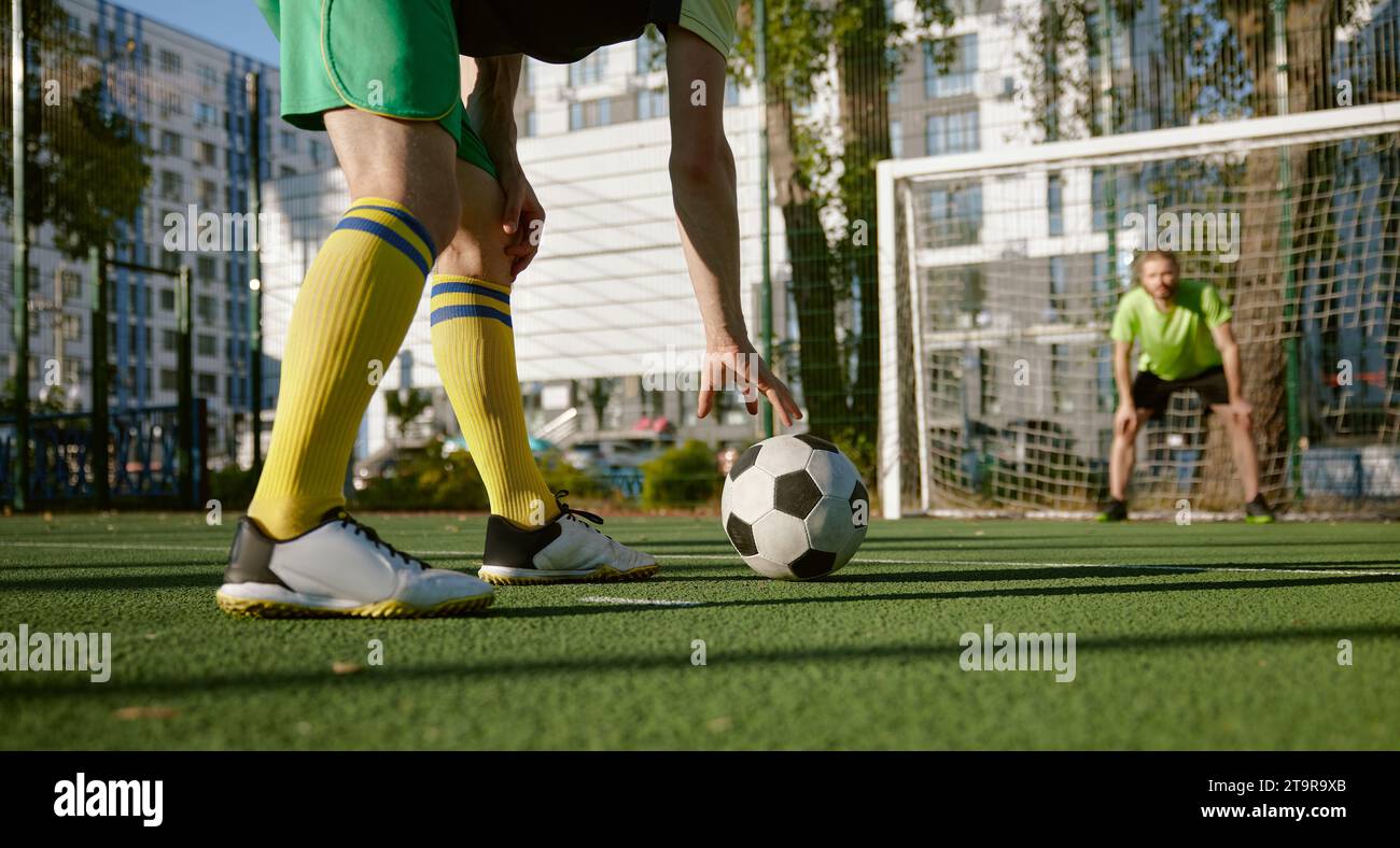 Football player going to hit soccer ball to score goal Stock Photo - Alamy