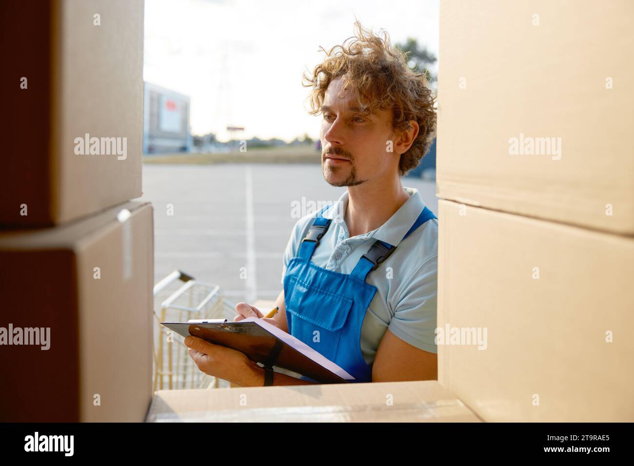 Closeup courier checking parcel package box in delivery truck Stock ...