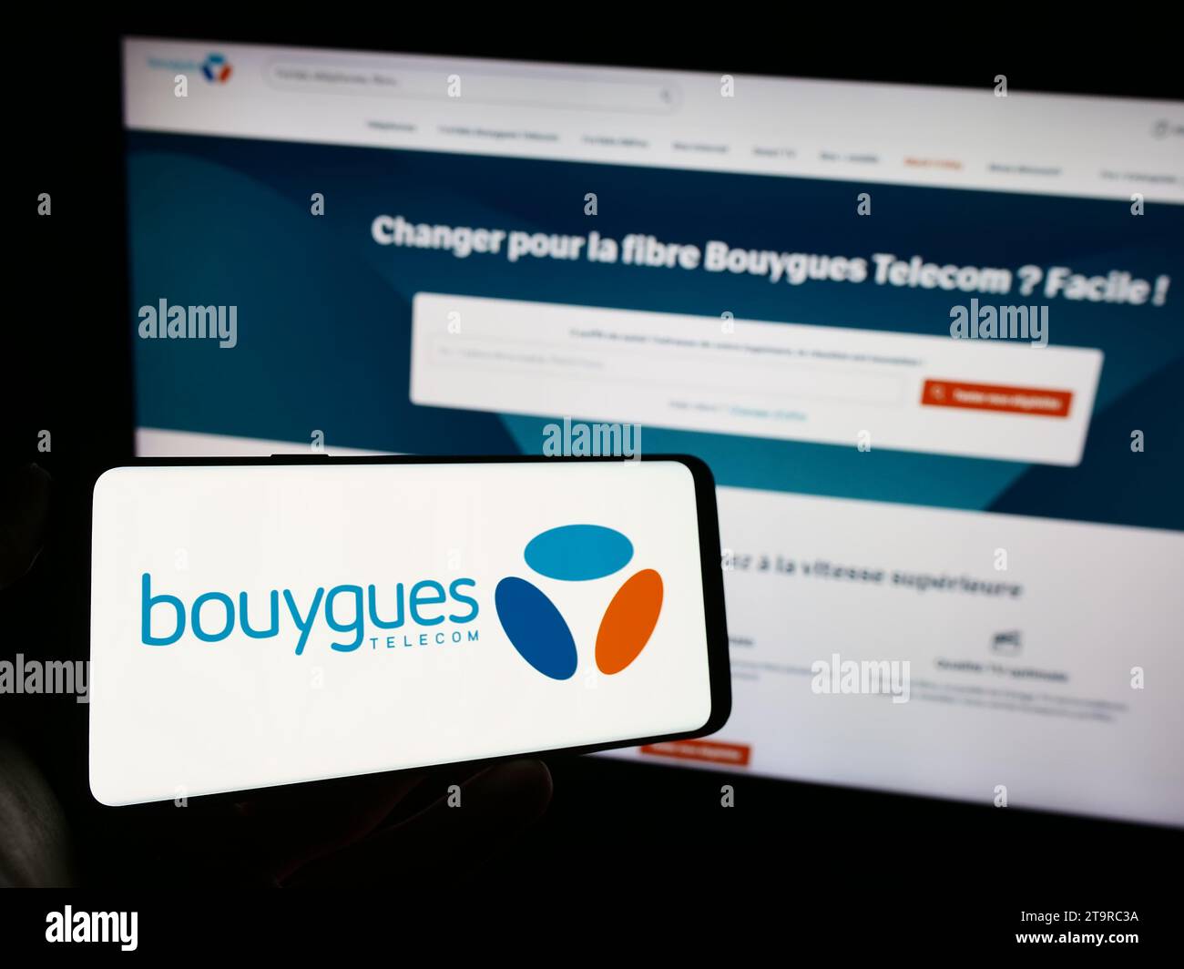 Person holding mobile phone with logo of French telecommunications ...