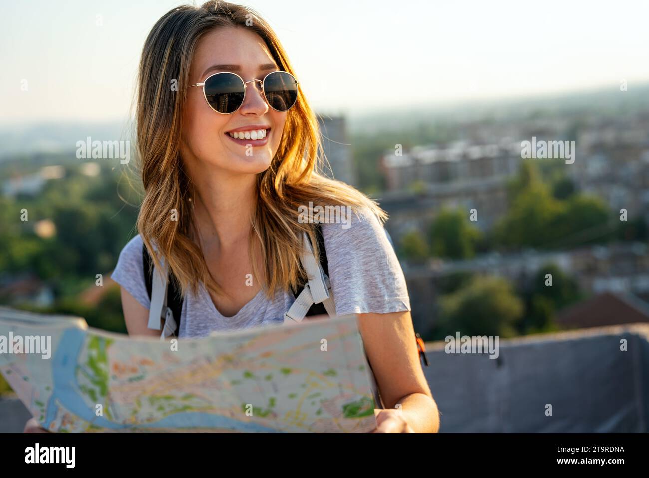 Young woman, student traveler with backpack enjoying summer vacation ...