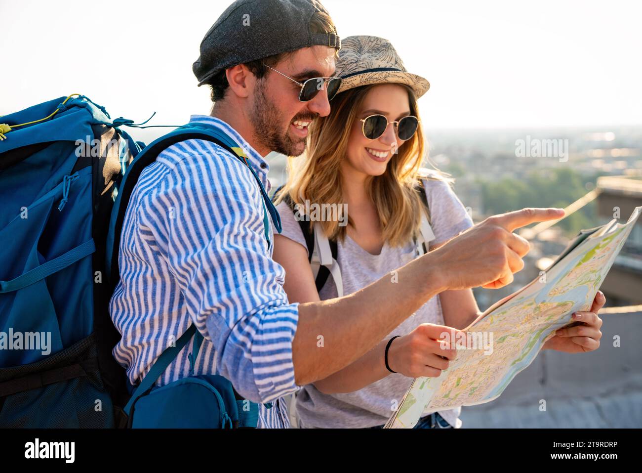 Happy couple on vacation sightseeing city with map. People travel fun ...