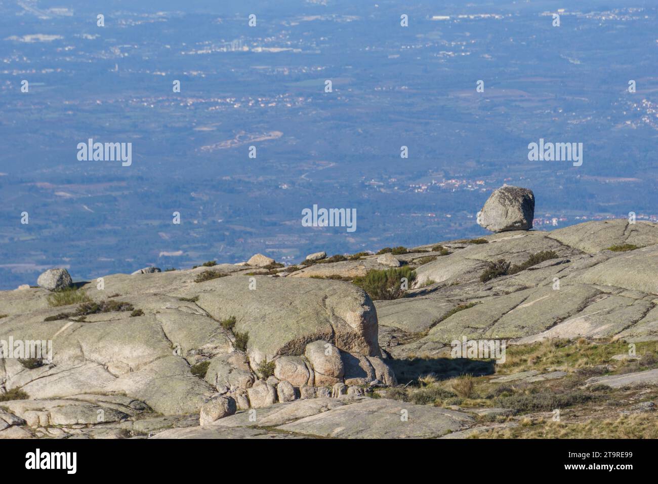 Single round washed stone laying on rock surface in a mountain ...