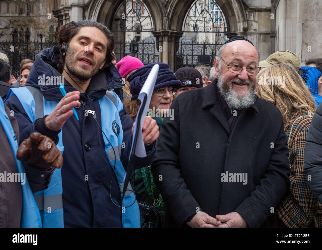 London, UK. 26th Nov, 2023. A volunteer steward next Chief Rabbi ...