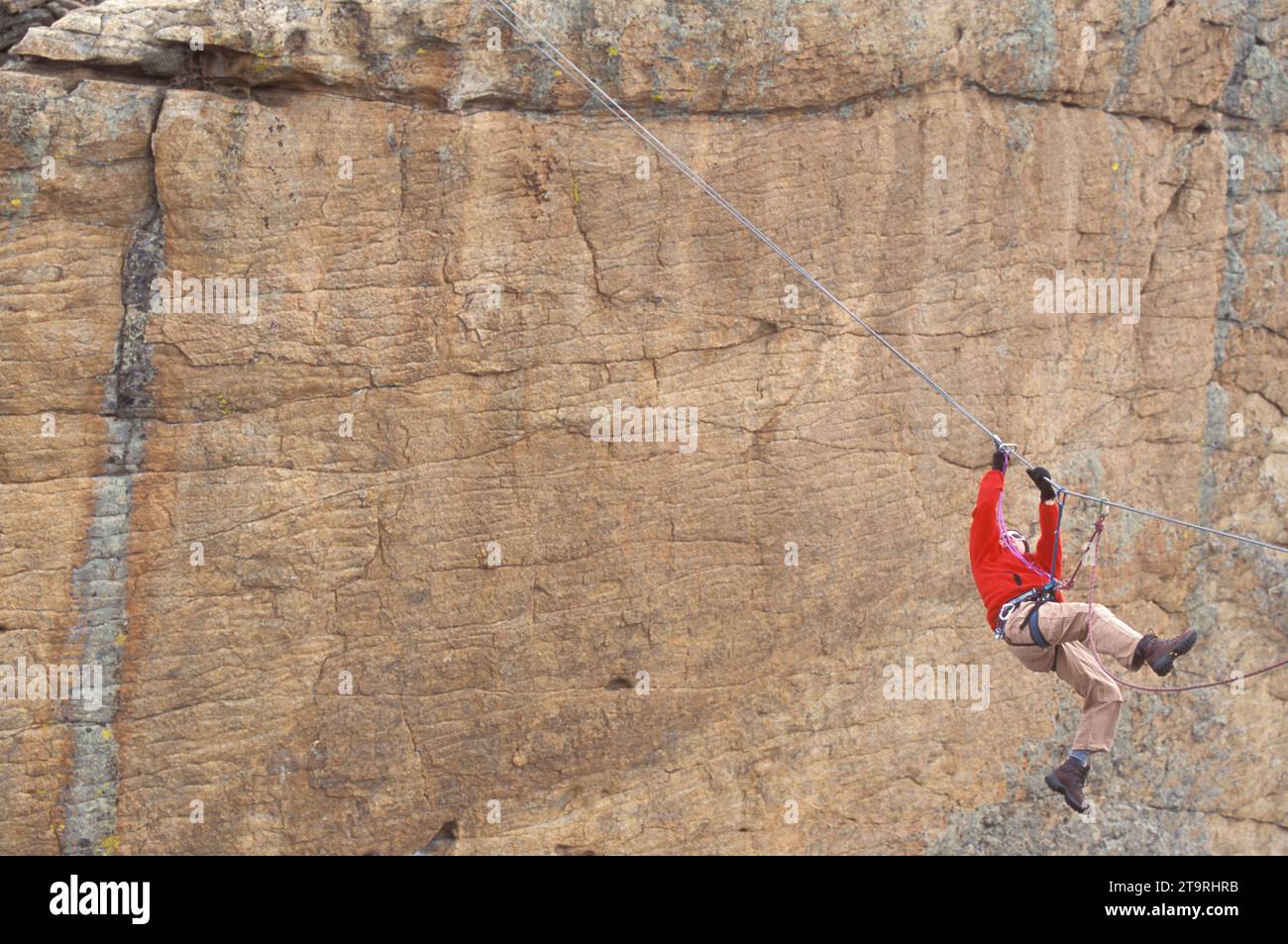 Climber crossing gorge by tyrolean traverse, Estes Park, Colorado Stock ...