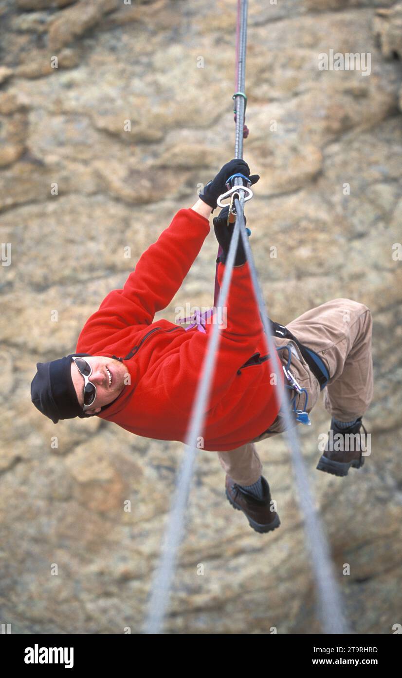 Climber crossing gorge by tyrolean traverse, Estes Park, Colorado, USA ...