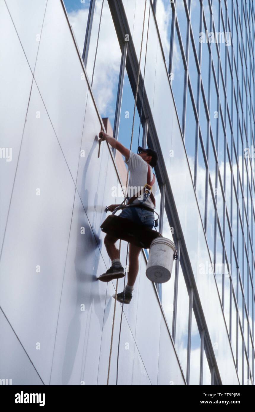 A window washer cleaning windows of a skyyscraper Stock Photo - Alamy