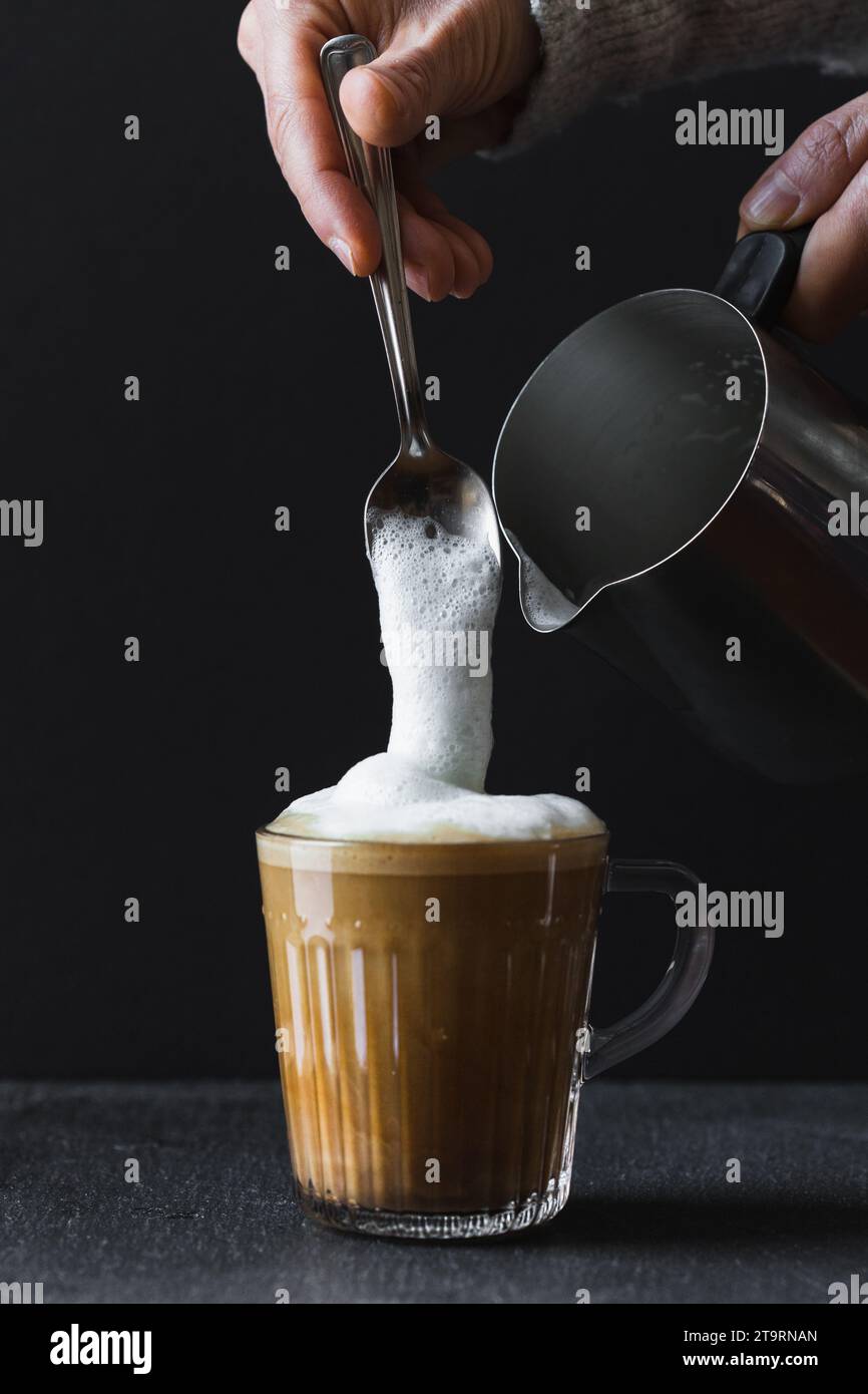 Pouring foam over a latte Stock Photo - Alamy